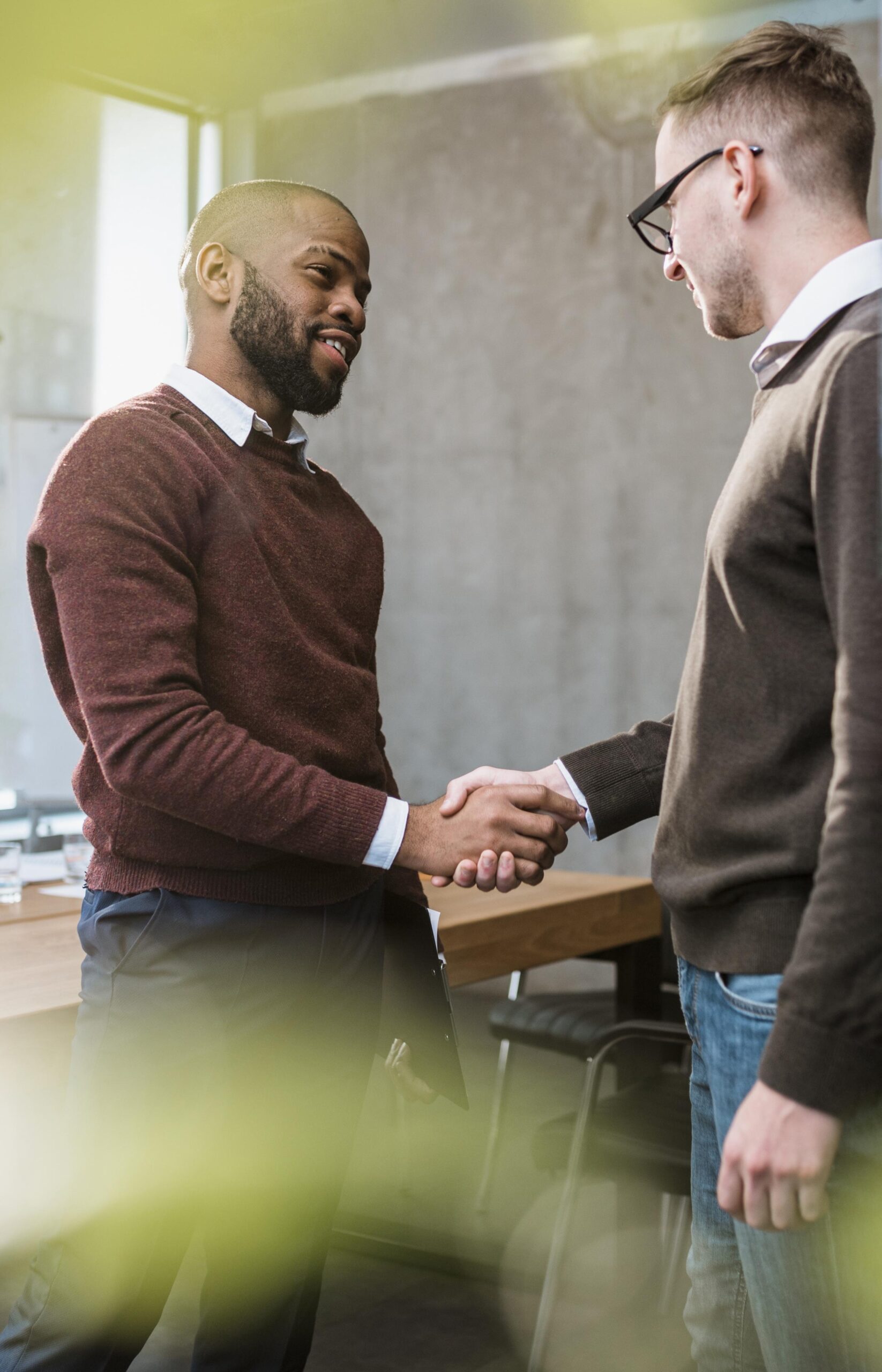 side-view-two-men-handshaking-agreement-after-meeting - Sophia side-view-two-men-handshaking-agreement-after-meeting - Sophia